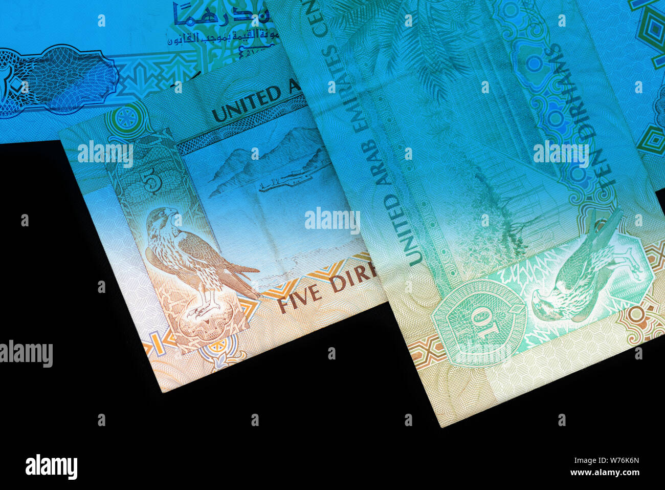 UAE dirham currency notes close up. Money background blue color toned ...
