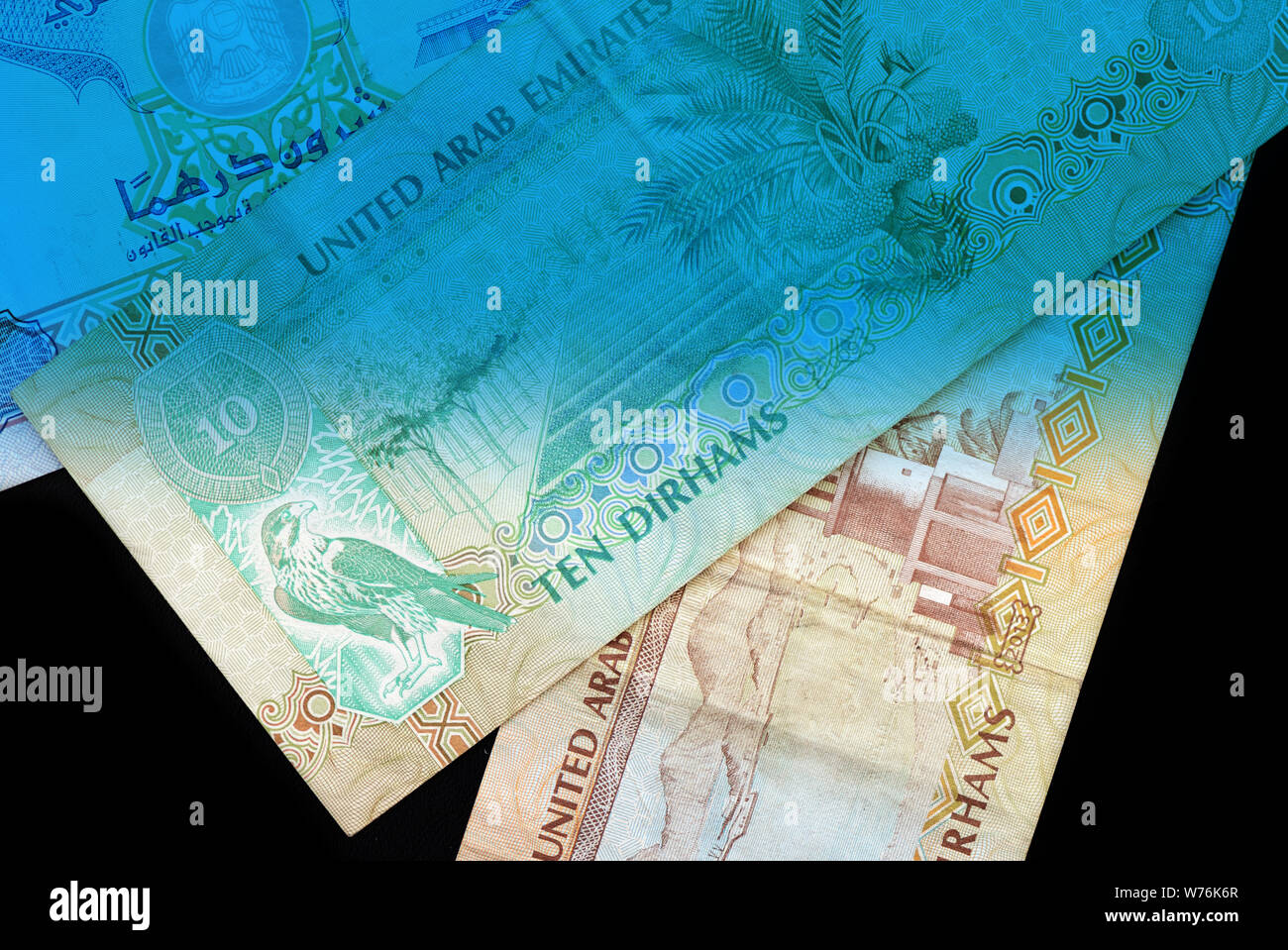 UAE dirham currency notes close up. Money background blue color toned ...