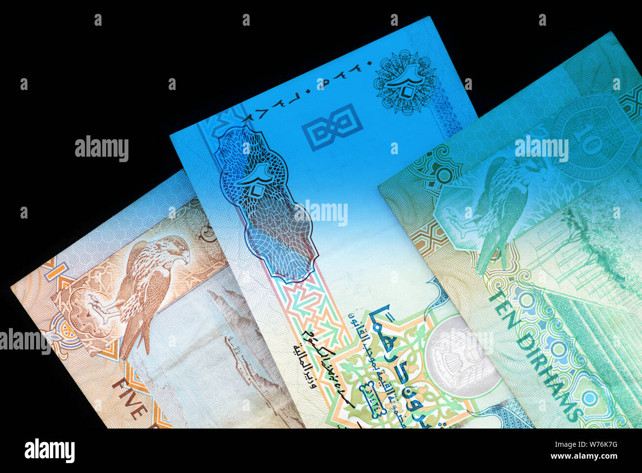 UAE dirham currency notes close up. Money background blue color toned ...