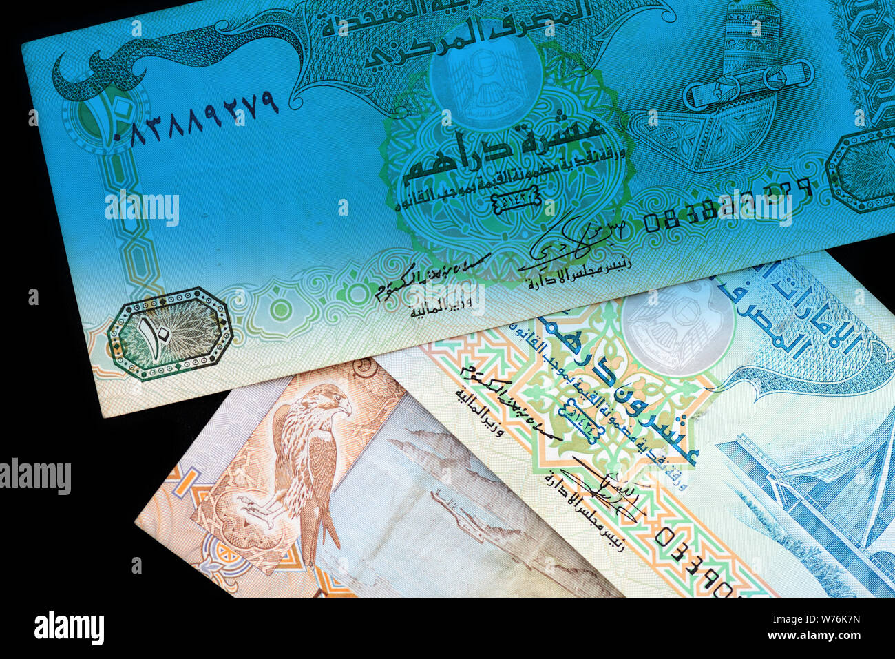 UAE dirham currency notes close up. Money background blue color toned ...