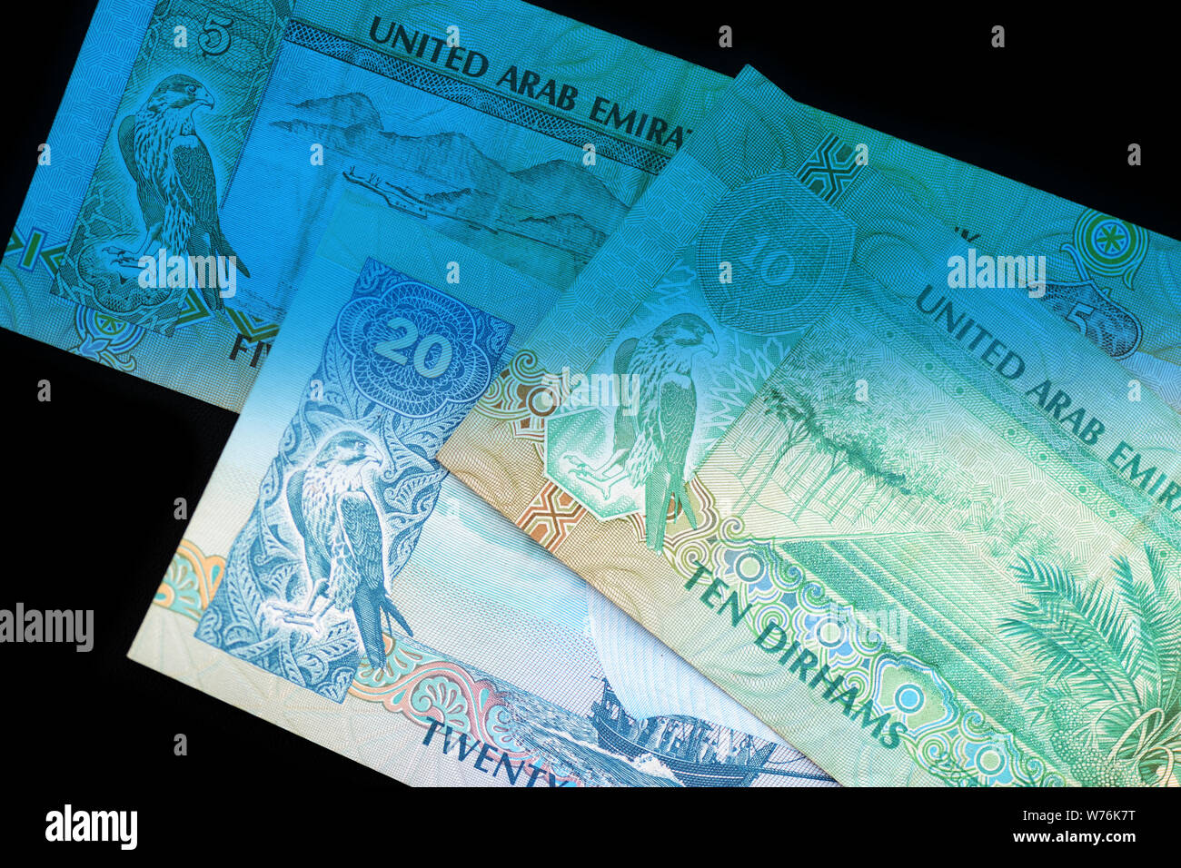 UAE dirham currency notes close up. Money background blue color toned ...