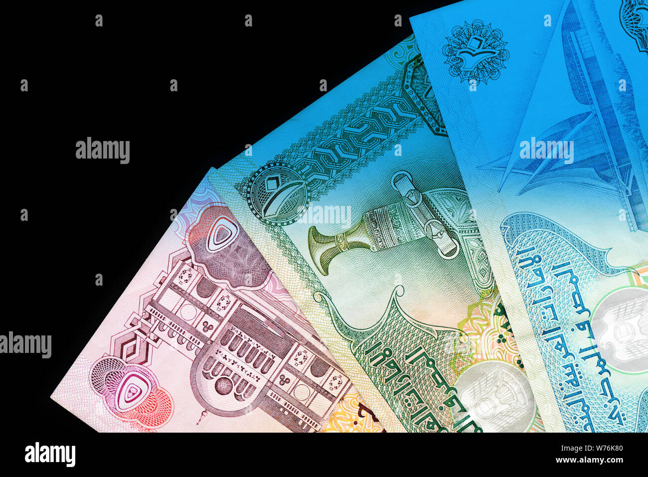 UAE dirham currency notes close up. Money background blue color toned ...