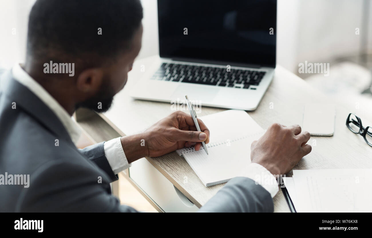 Businessman writing notes on notepad hi-res stock photography and ...