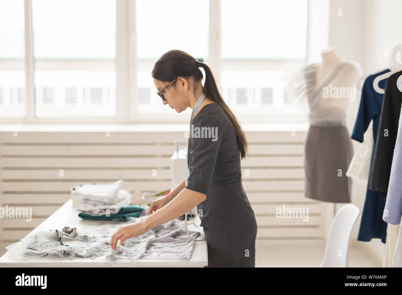 Dressmaker, fashion designer and tailor concept - Young woman designer ...