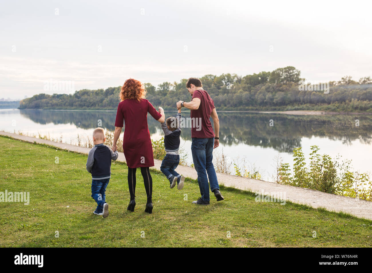 Parent, childhood and nature concept - Family playing with two sons by ...