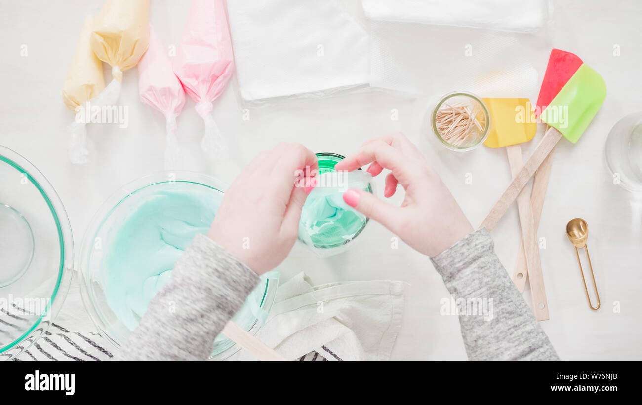 Step by step. Flat lay. Mixing royal icing to decorate Easter sugar ...
