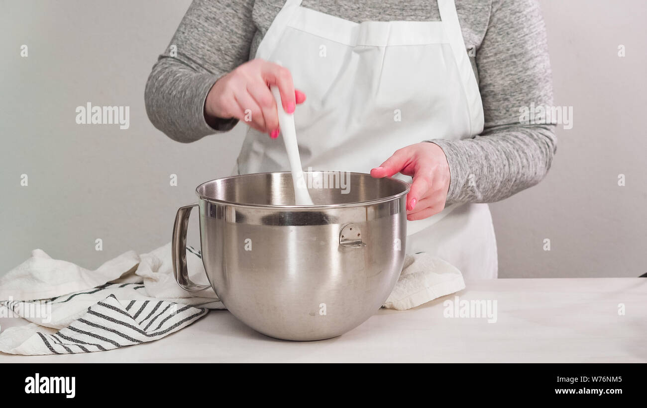 Step by step. Flat lay. Mixing royal icing in electric kitchen mixer ...