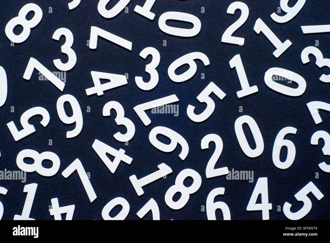 Random white number on black background Stock Photo - Alamy