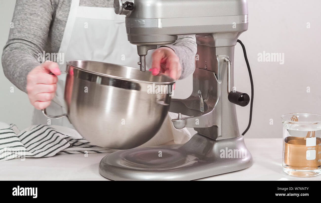 Step by step. Flat lay. Mixing royal icing in electric kitchen mixer ...