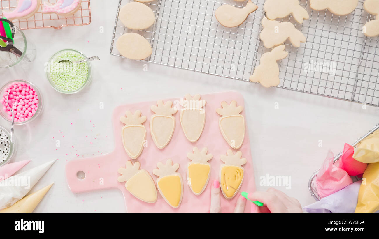 Step by step. Flat lay. Decorating Easter sugar cookies with rotal ...