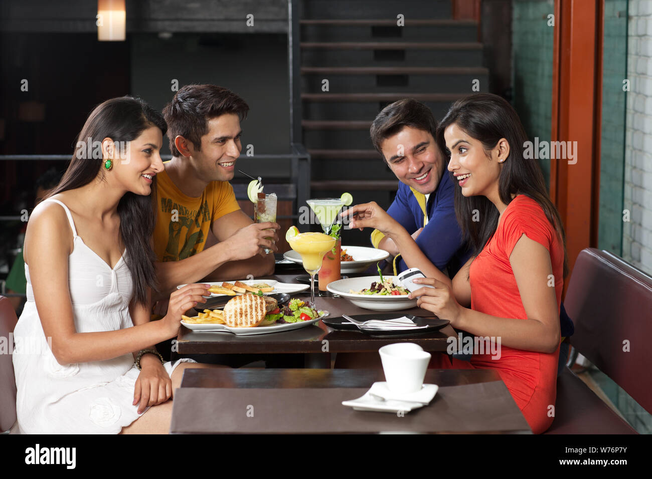Friends having dinner in a restaurant Stock Photo - Alamy