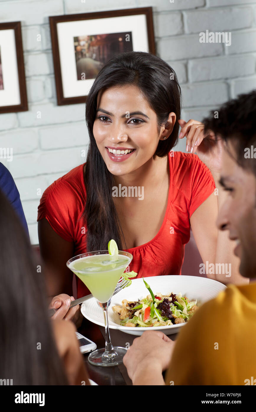 Indian friends having dinner in a restaurant Stock Photo - Alamy