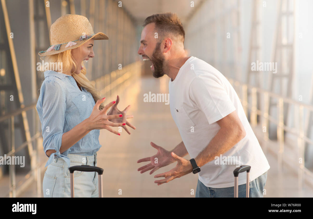 Young tourists arguing, arriving at airport, side view Stock Photo - Alamy