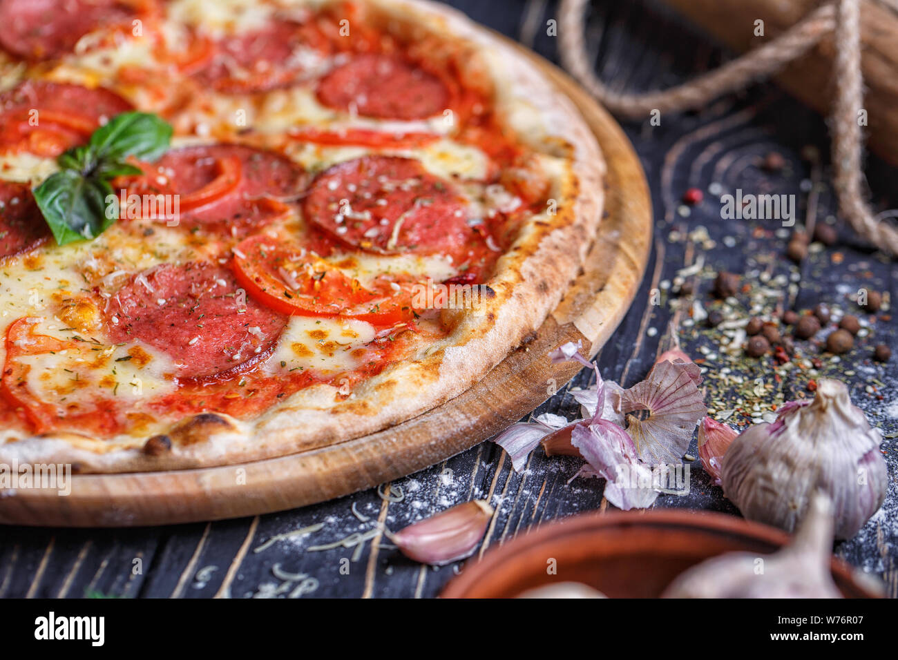 Tender pizza with sausage, tomatoes and cheese Stock Photo - Alamy