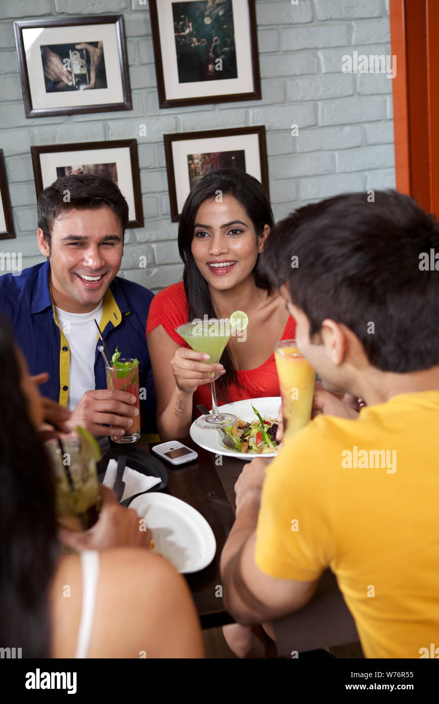 Friends having juice in a restaurant Stock Photo - Alamy