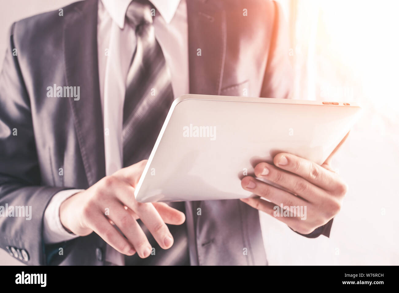 successful businessman with digital tablet on light background Stock ...