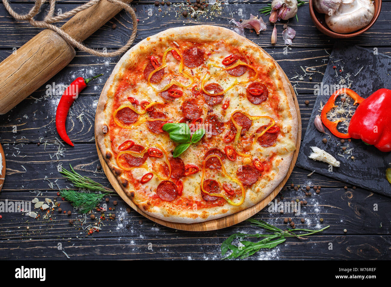 Burning pizza with sausage, bulgarian pepper and chili pepper Stock ...