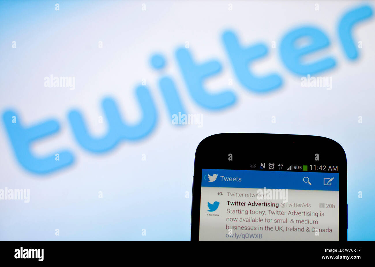 A picture shows a smart phone with Twitter advertising tweet and a logo ...
