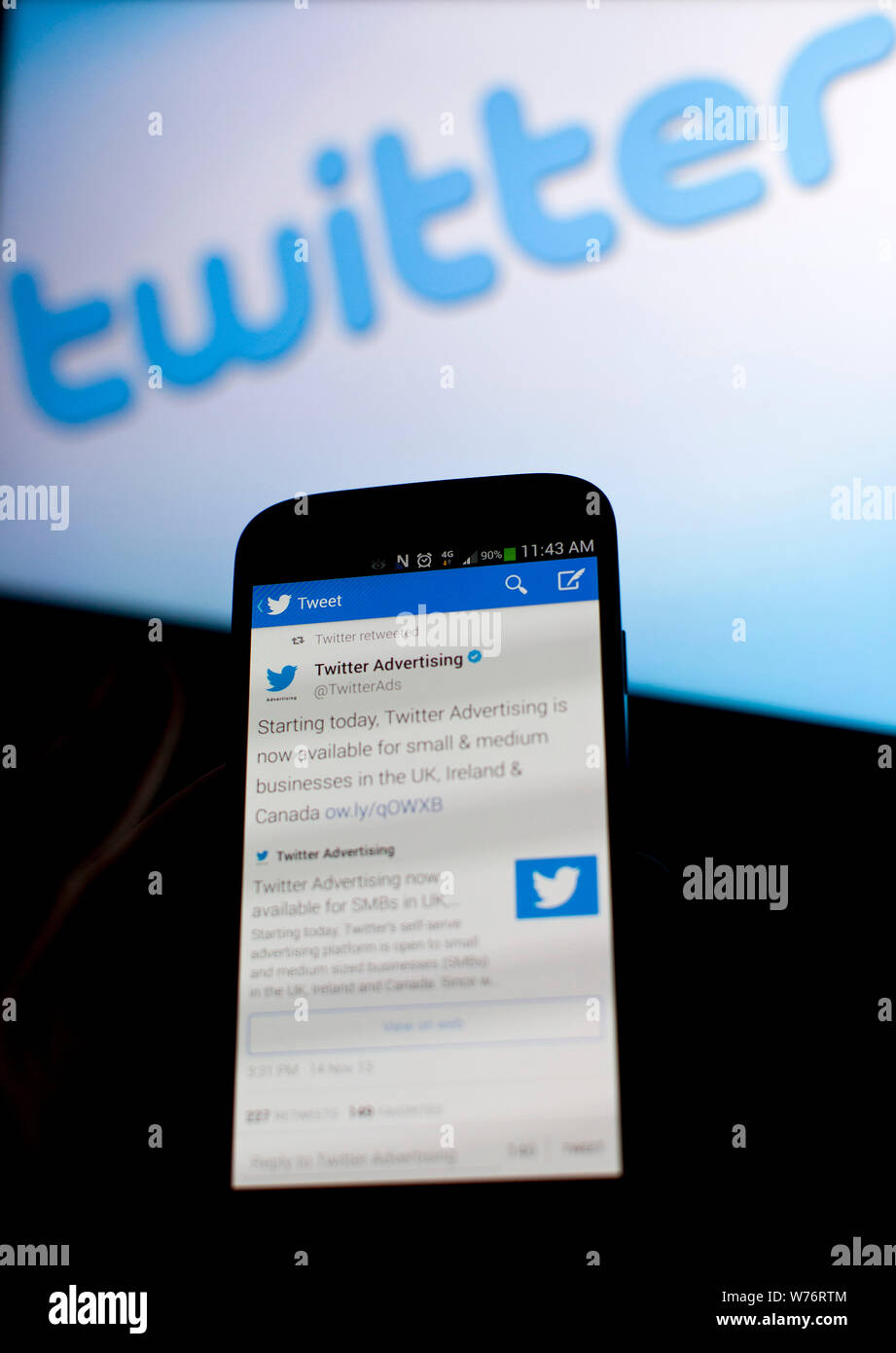 A picture shows a smart phone with Twitter advertising tweet and a logo ...