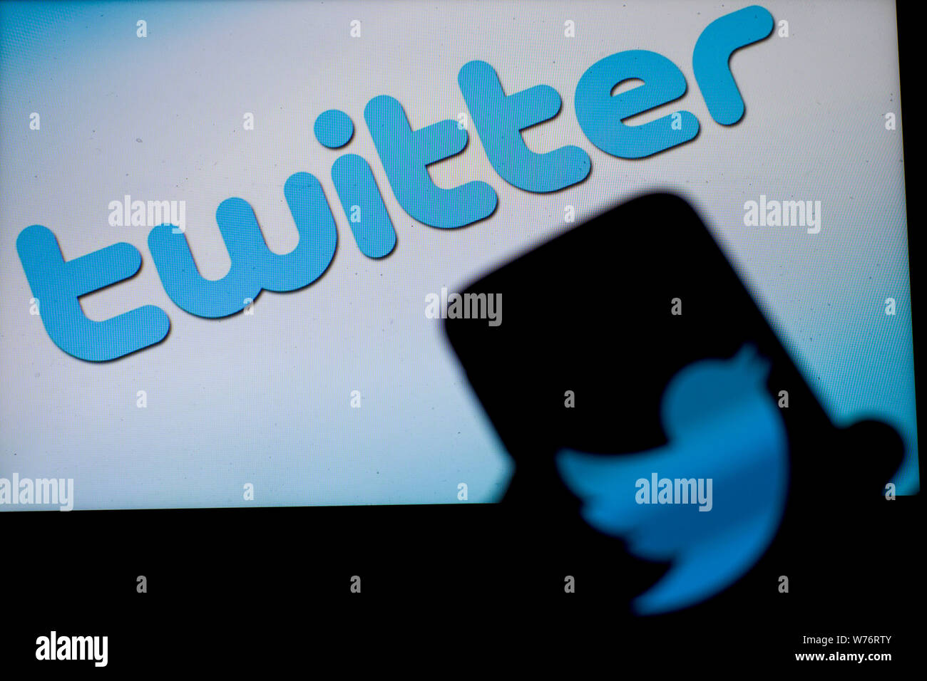 A picture shows a smart phone with Twitter advertising tweet and a logo ...