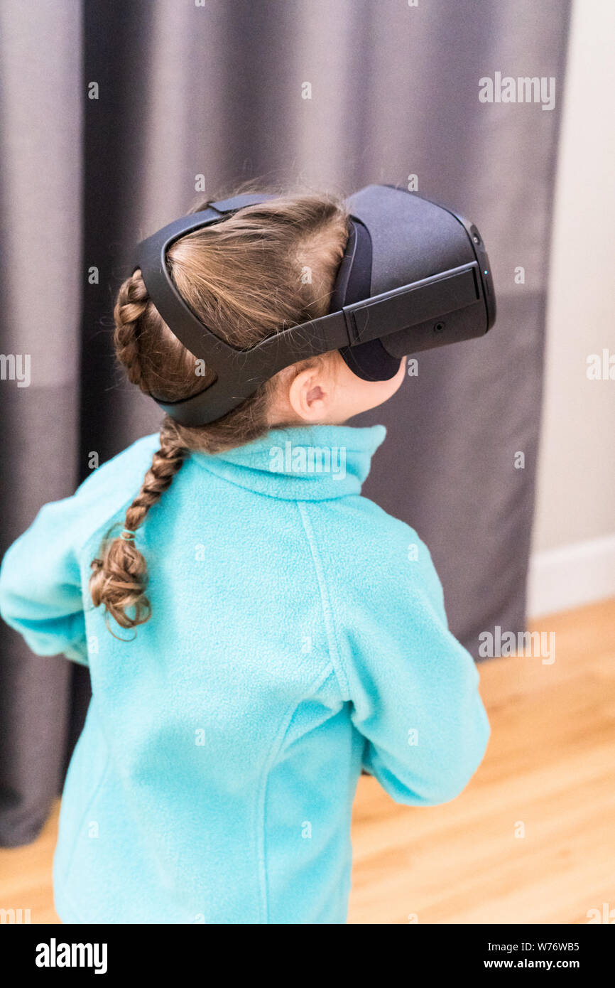 Little girl playing VR kids game in the living room Stock Photo - Alamy