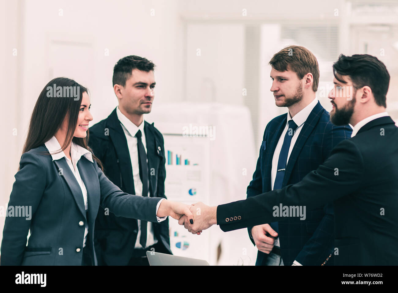 handshake of business partners after signing the contract in the ...