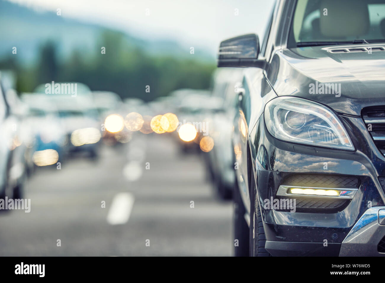 Cars drive in dense stream hi-res stock photography and images - Alamy