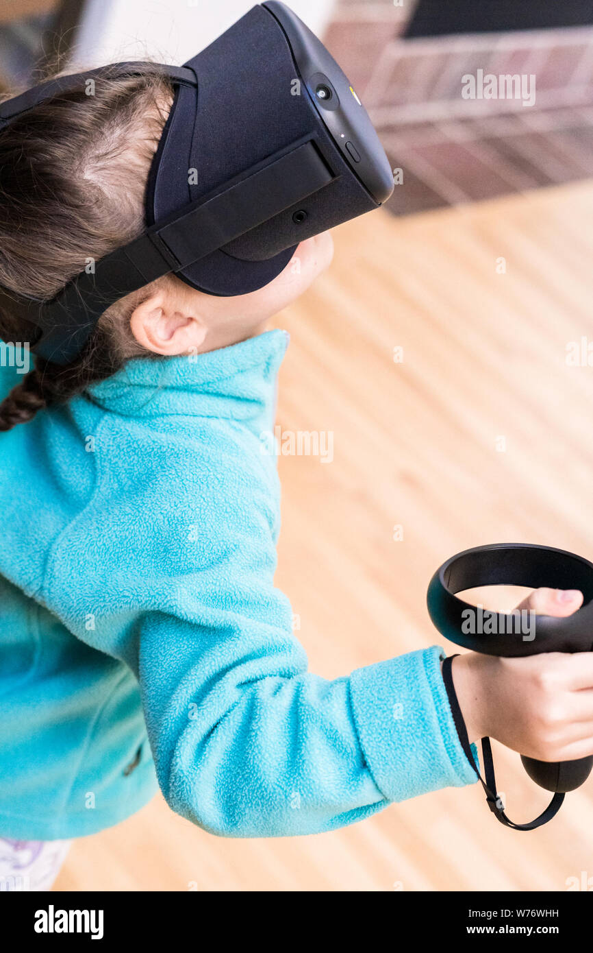 Little girl playing VR kids game in the living room Stock Photo - Alamy
