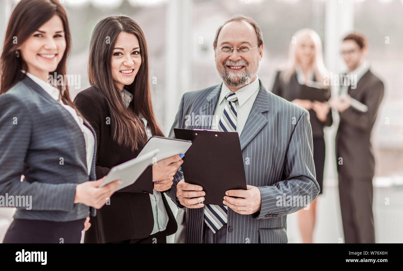successful businessman and his two assistants with documents on the ...