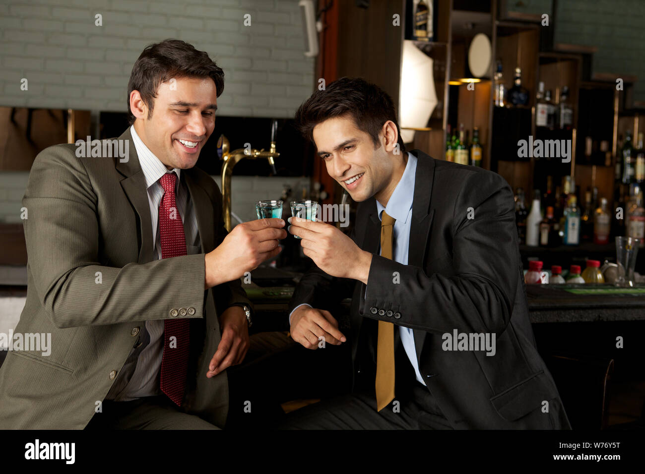 Young smiling businessman toasting hi-res stock photography and images ...