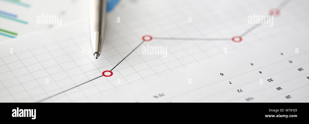 Silver pen lie on paper chart with Stock Photo - Alamy