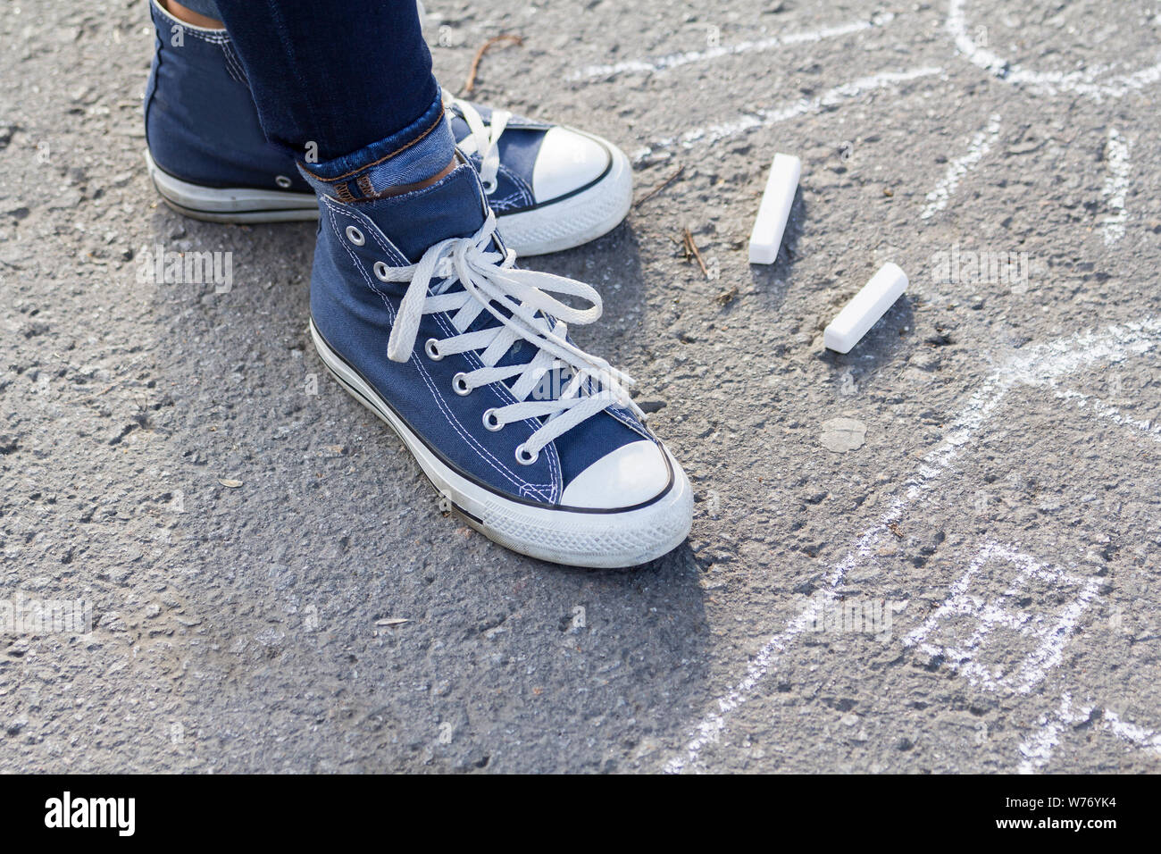 Feet girl in sneakers cost about drawing a chalk on the pavement Stock ...