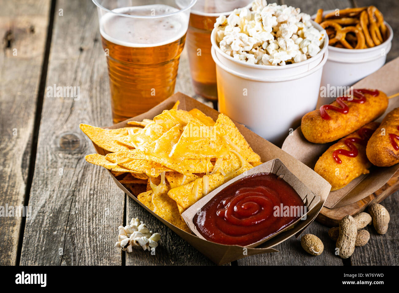 Selection of stadium game foods - nachos, pop corn, pretzels, corn dogs ...
