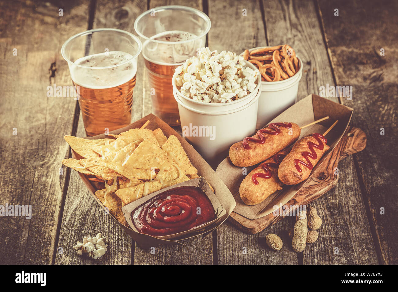 Selection of stadium game foods - nachos, pop corn, pretzels, corn dogs ...
