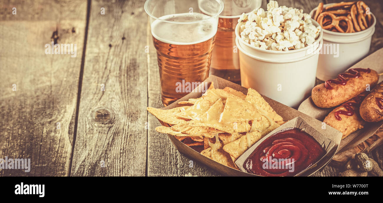 Selection of stadium game foods - nachos, pop corn, pretzels, corn dogs ...