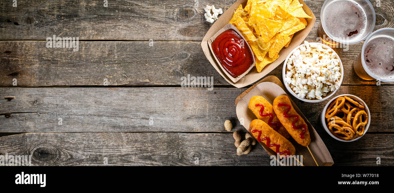 Selection of stadium game foods - nachos, pop corn, pretzels, corn dogs ...