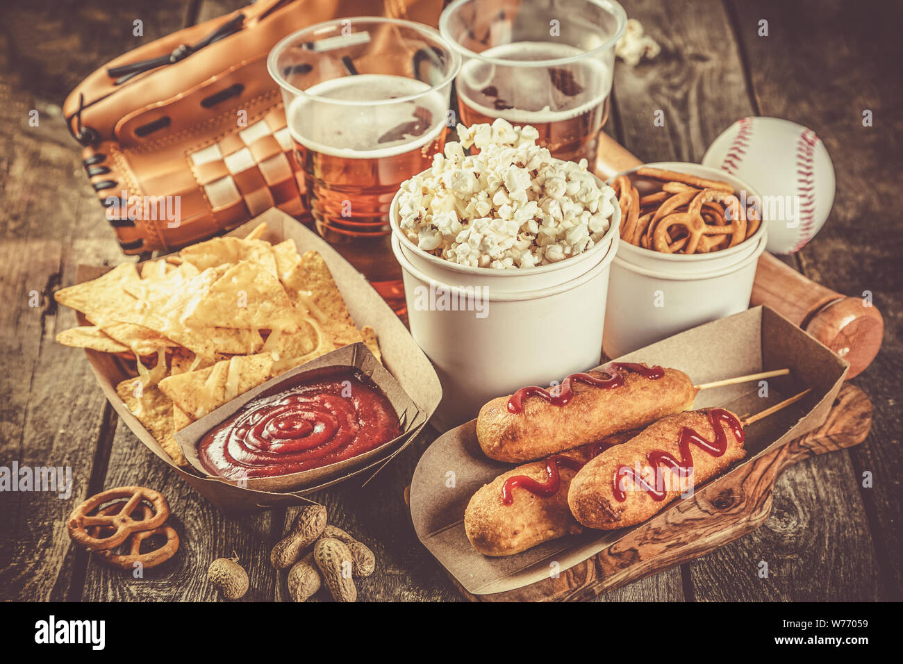 Selection of stadium game foods - nachos, pop corn, pretzels, corn dogs ...