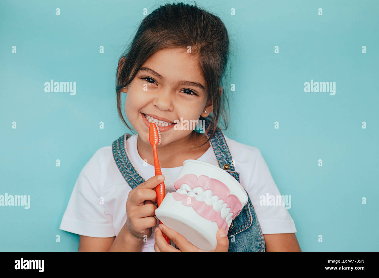 will teach you how to brush your teeth. Mixed race little girl with ...