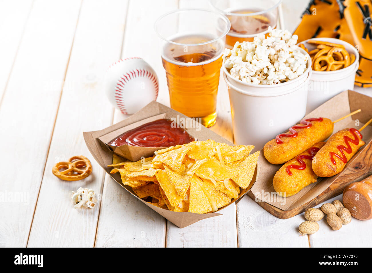 Selection of stadium game foods - nachos, pop corn, pretzels, corn dogs ...