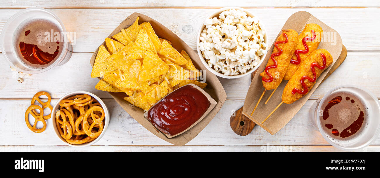 Selection of stadium game foods - nachos, pop corn, pretzels, corn dogs ...