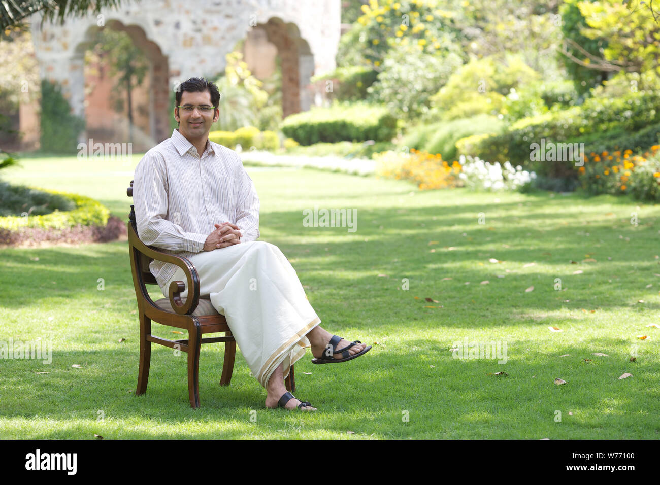 South Indian man sitting on a chair Stock Photo - Alamy