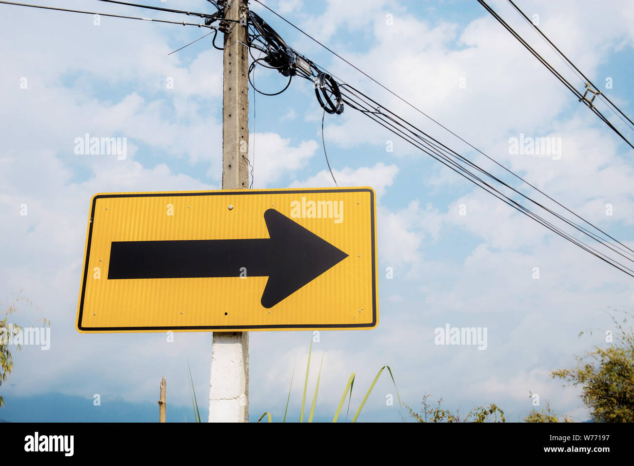 Traffic signs on electric pole with the blue sky Stock Photo - Alamy