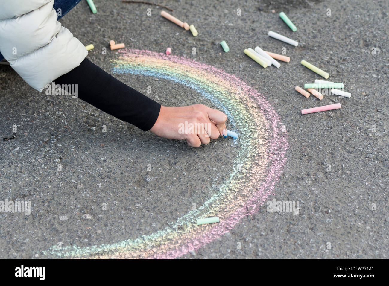 Hand draws with crayons colored Rainbow girl on the pavement Stock ...