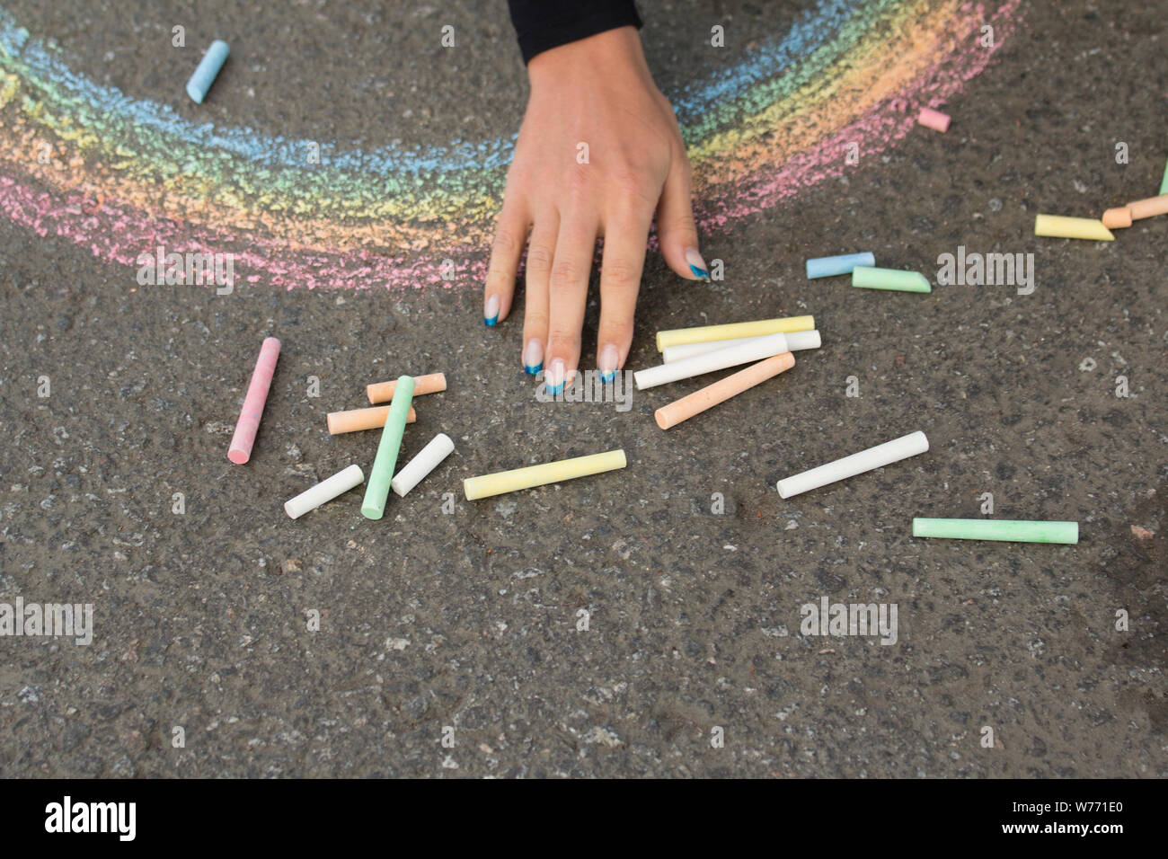 Hand draws with crayons colored Rainbow girl on the pavement Stock ...