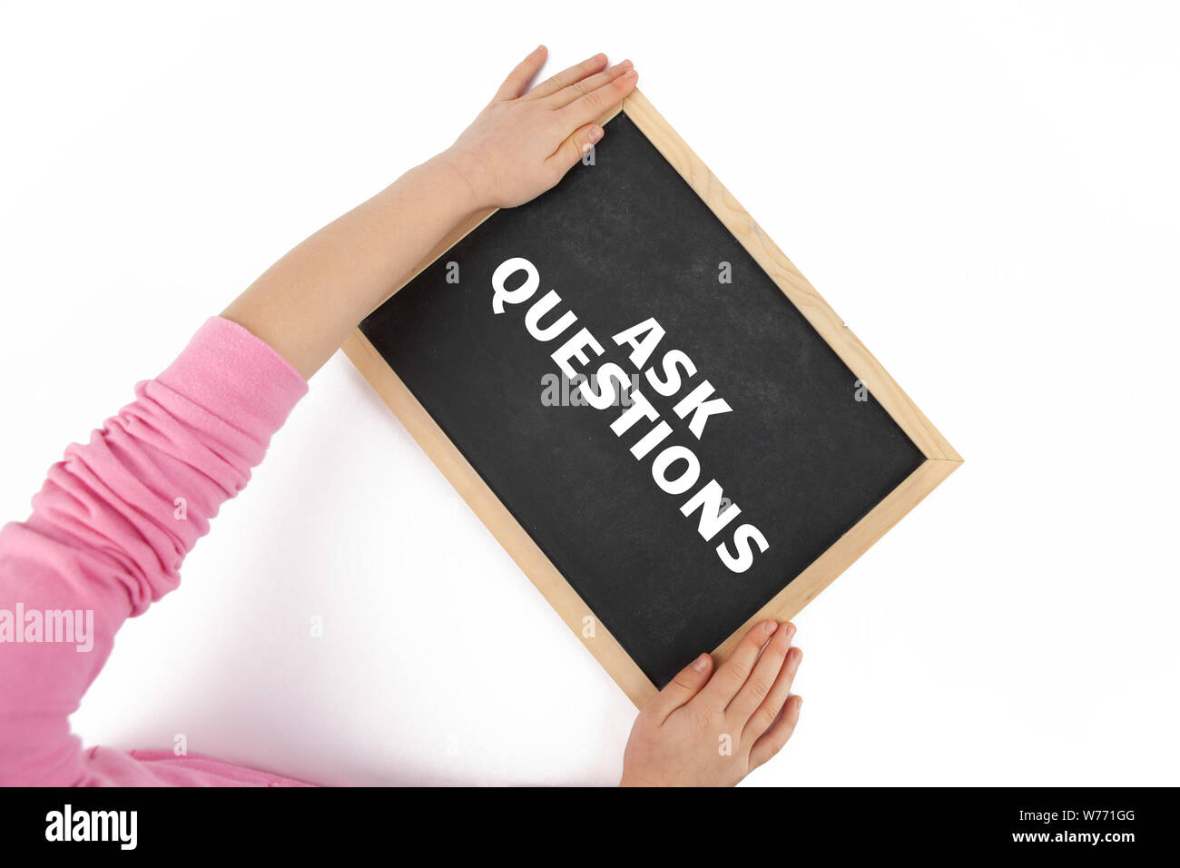 Child hands holding blackboard with text Ask Questions - top view ...