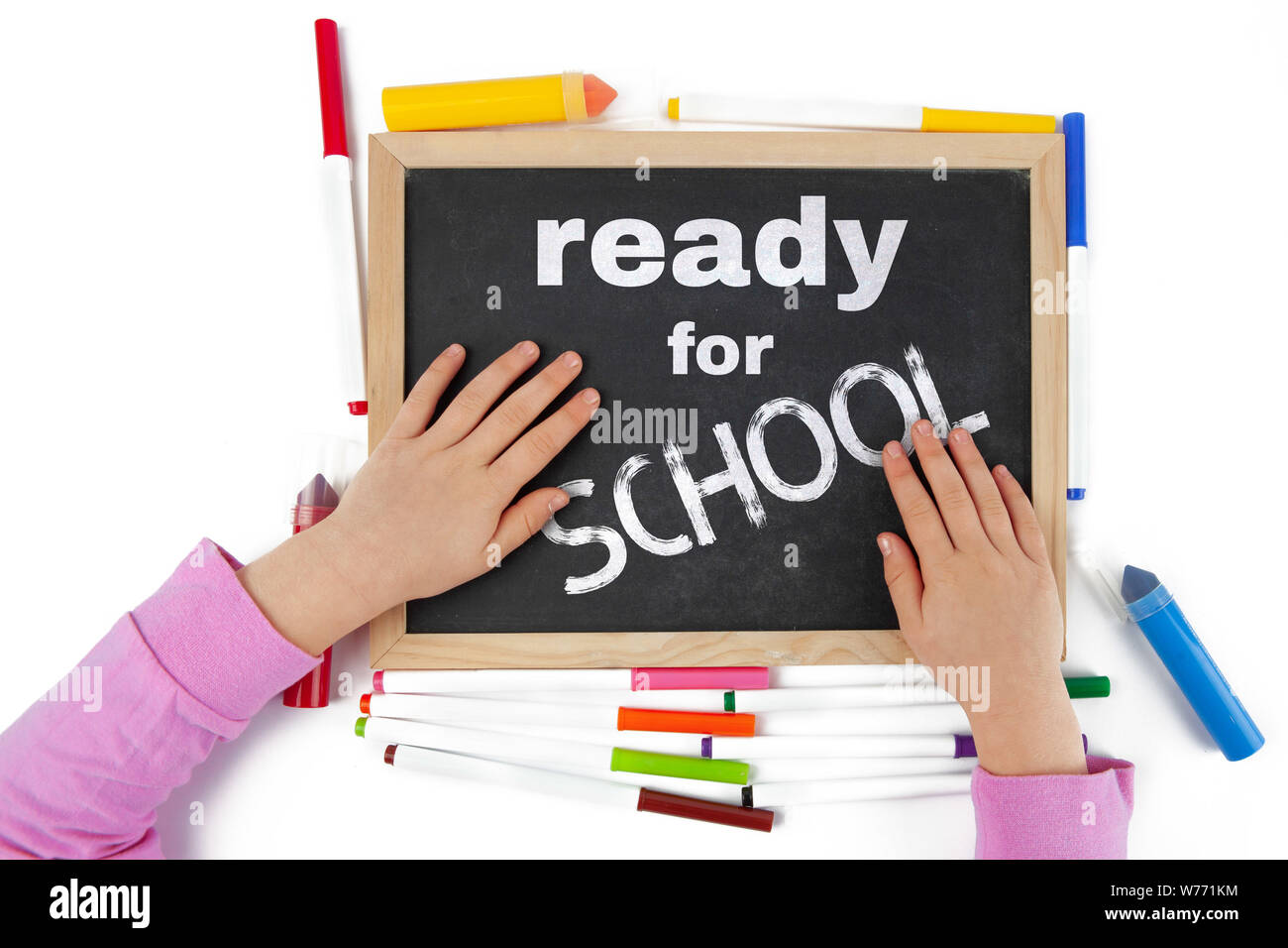 Getting ready for school concept depicted with child hands on ...