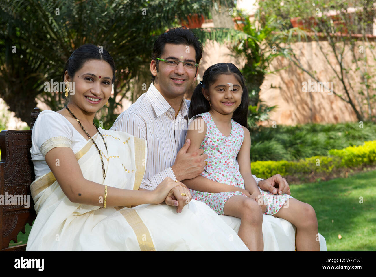 South Indian family sitting together in a lawn Stock Photo - Alamy