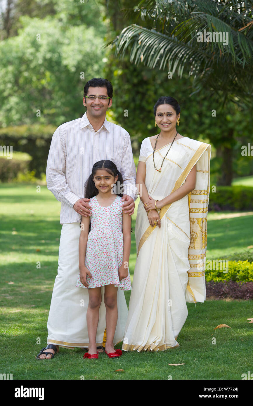 South Indian family standing together in a lawn Stock Photo - Alamy