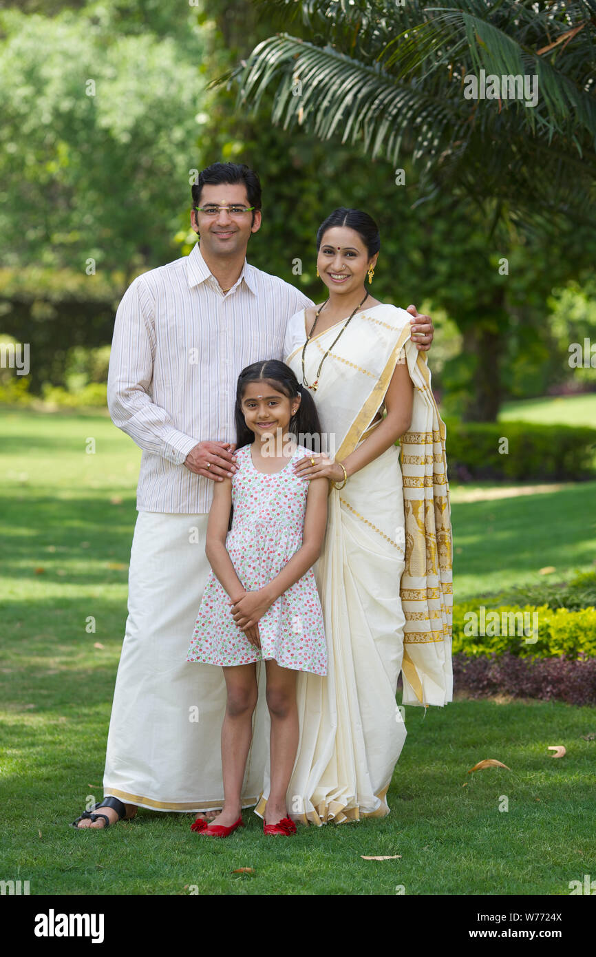 South Indian family standing together in a lawn Stock Photo - Alamy