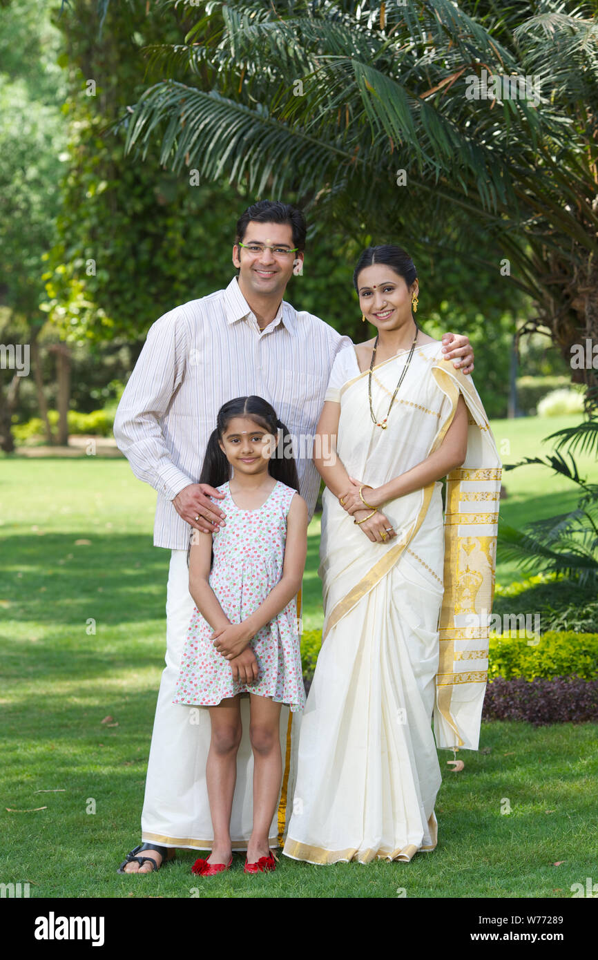 South Indian family standing together in a lawn Stock Photo - Alamy